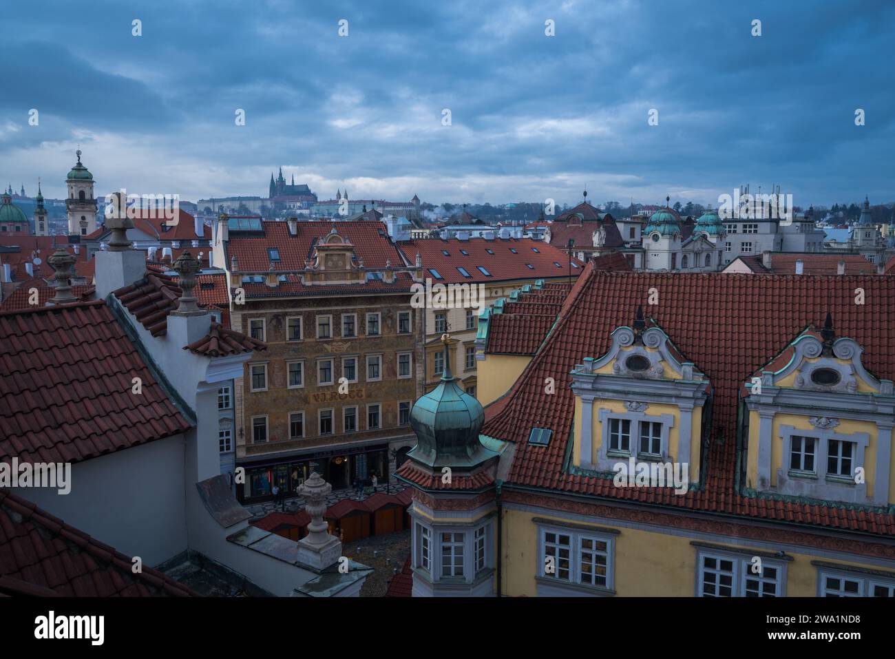 Prague rooftops and distant castle with cloudy sky Stock Photo - Alamy