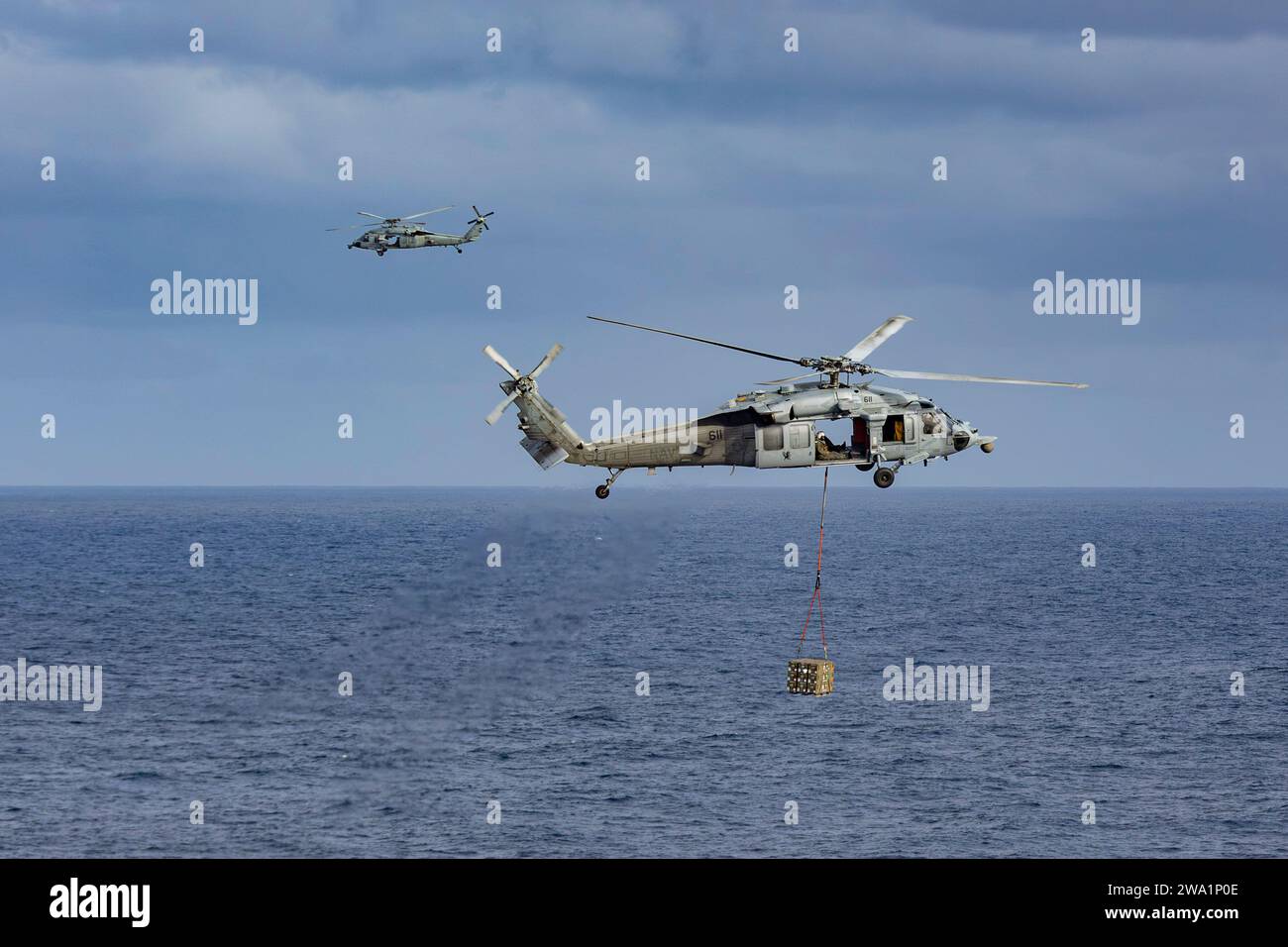 Two MH-60S Sea Hawk helicopters participated in an ammunition transfer ...