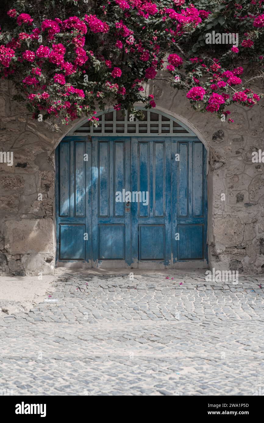 A beautiful weathered blue doorway surrounded by sandy coloured stone ...