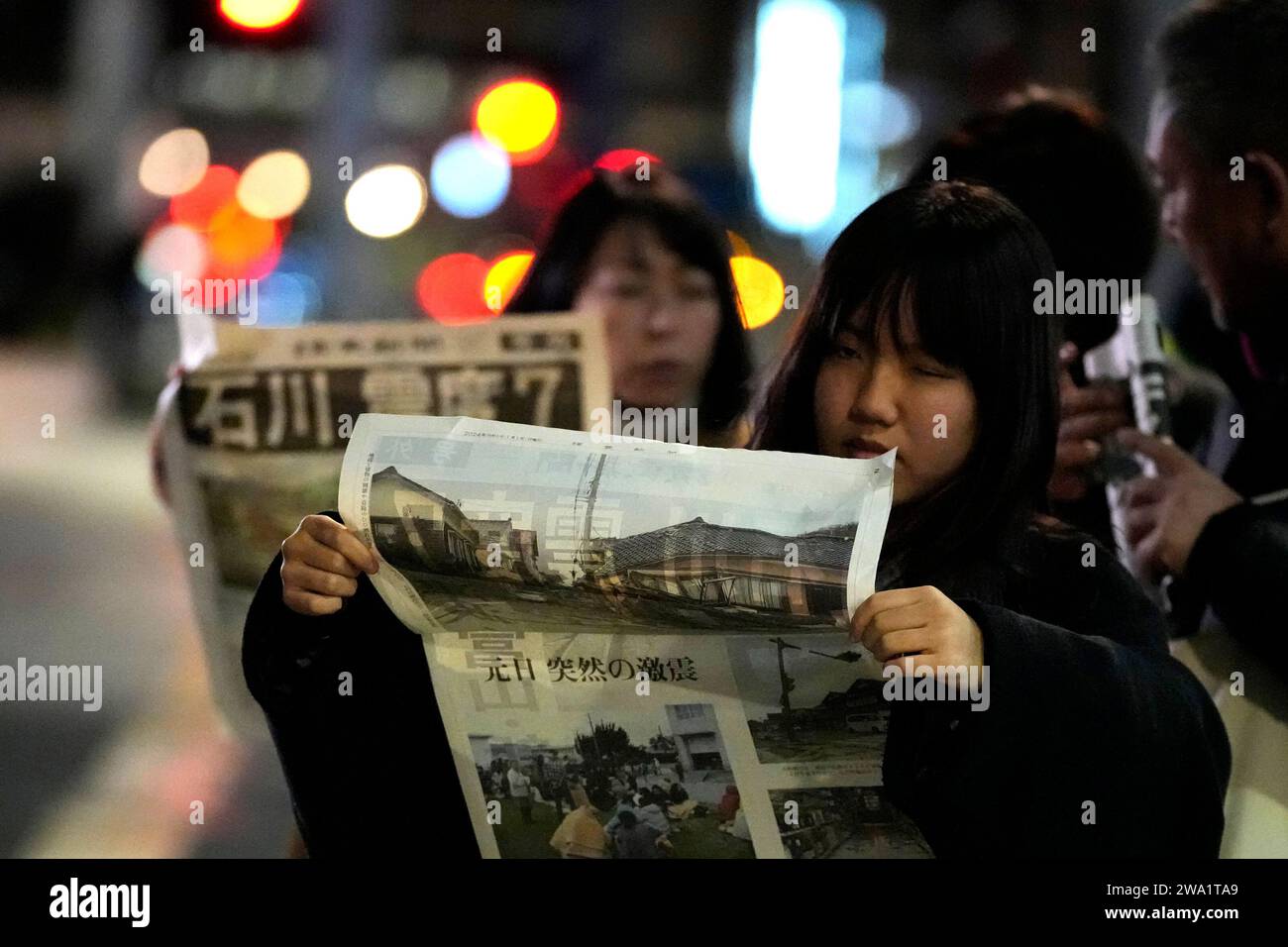 People read extra edition of Yomiuri Shimbun newspaper reporting the ...