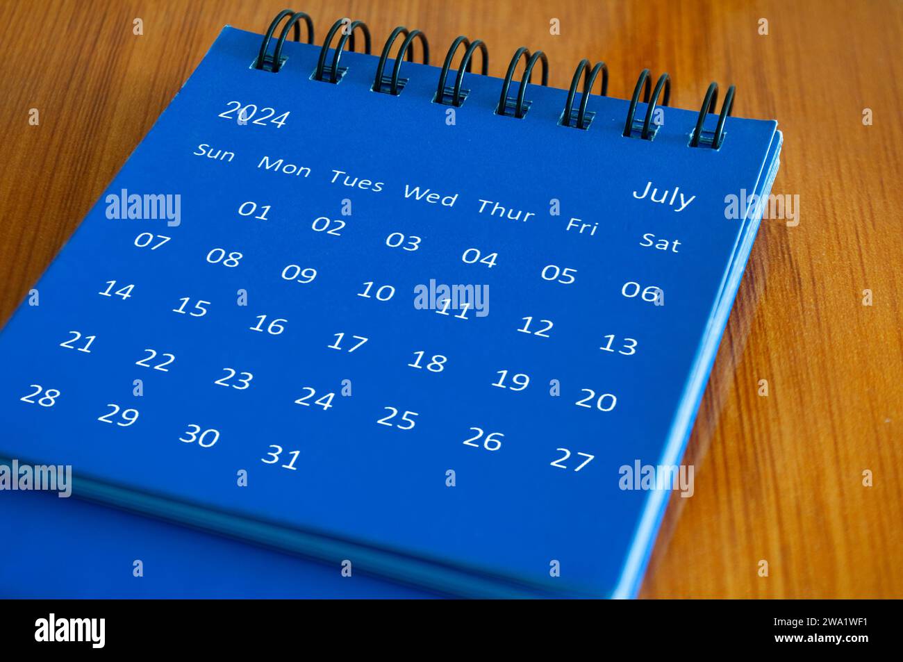 July 2024 table calendar on wooden desk. Time and calendar concept ...