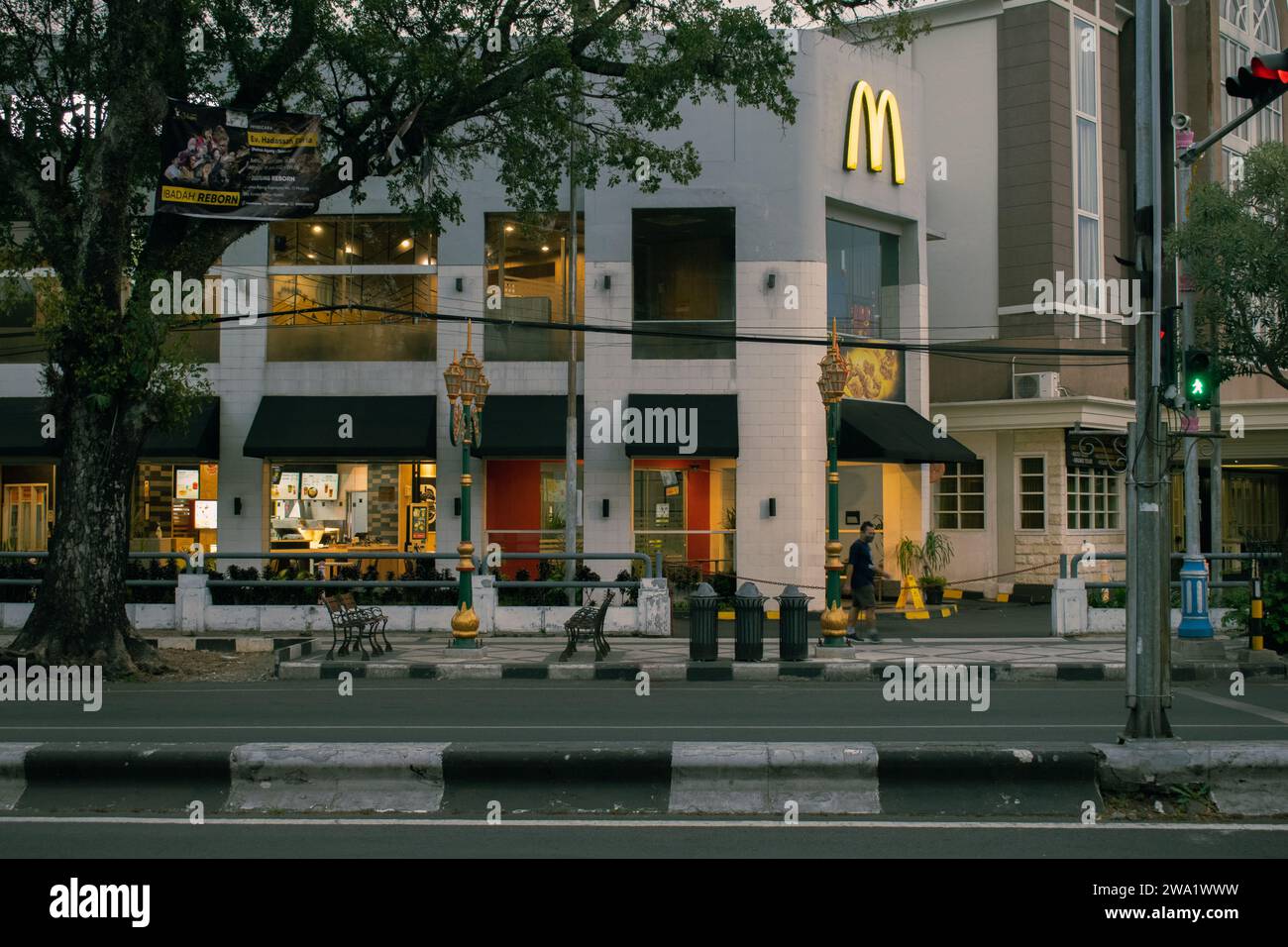 Malang, Indonesia, 01 January 2024 : A man walks in front of McDonald's ...