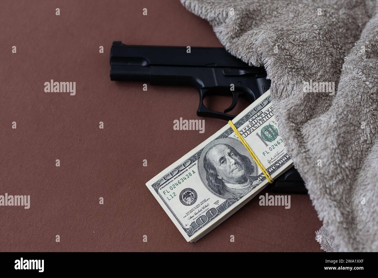 Pile of US dollar cash and a black pistol gun. Seen from above Stock ...