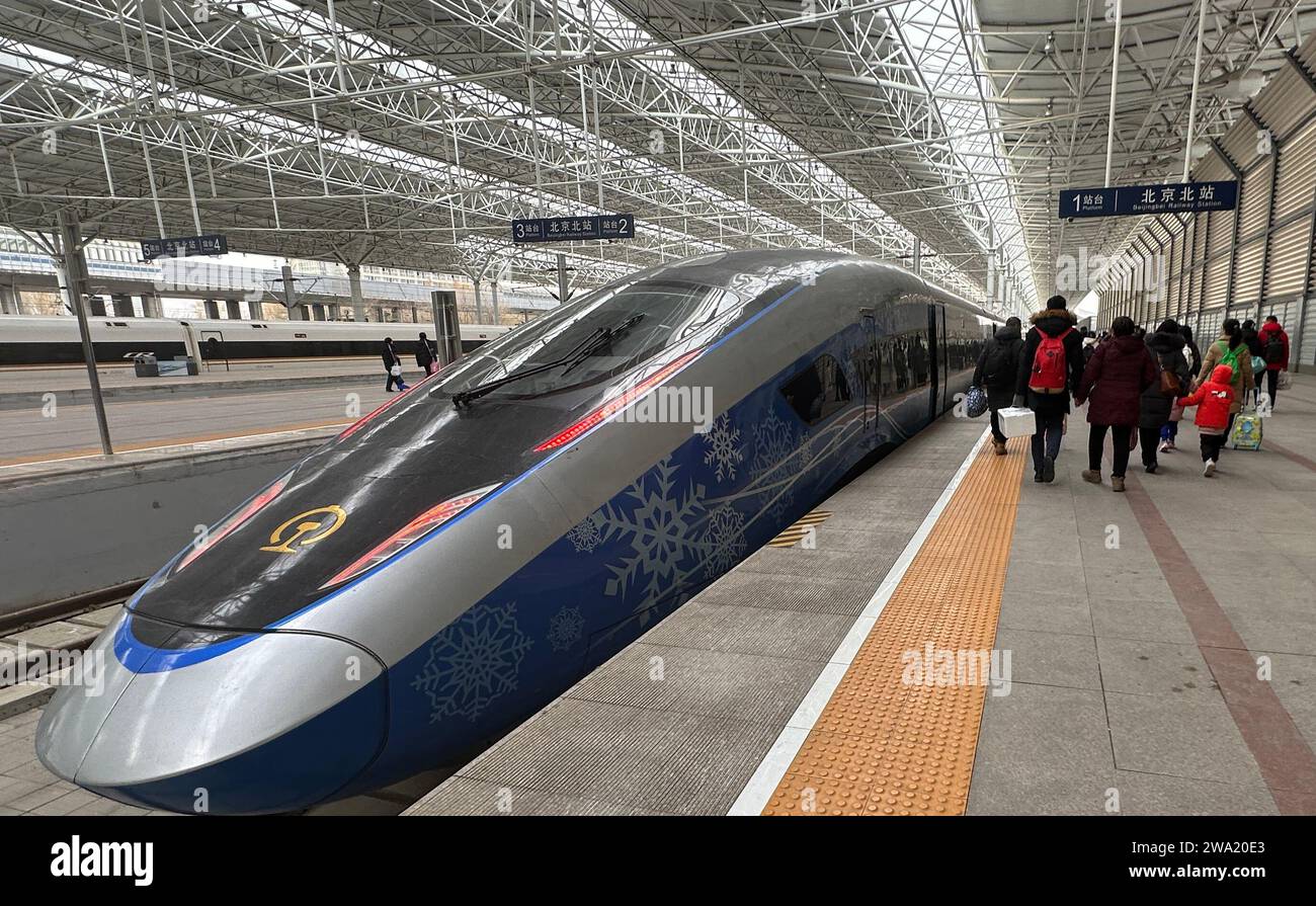 Beijing, China. 1st Jan, 2024. Travelers take a train at the Beijing ...