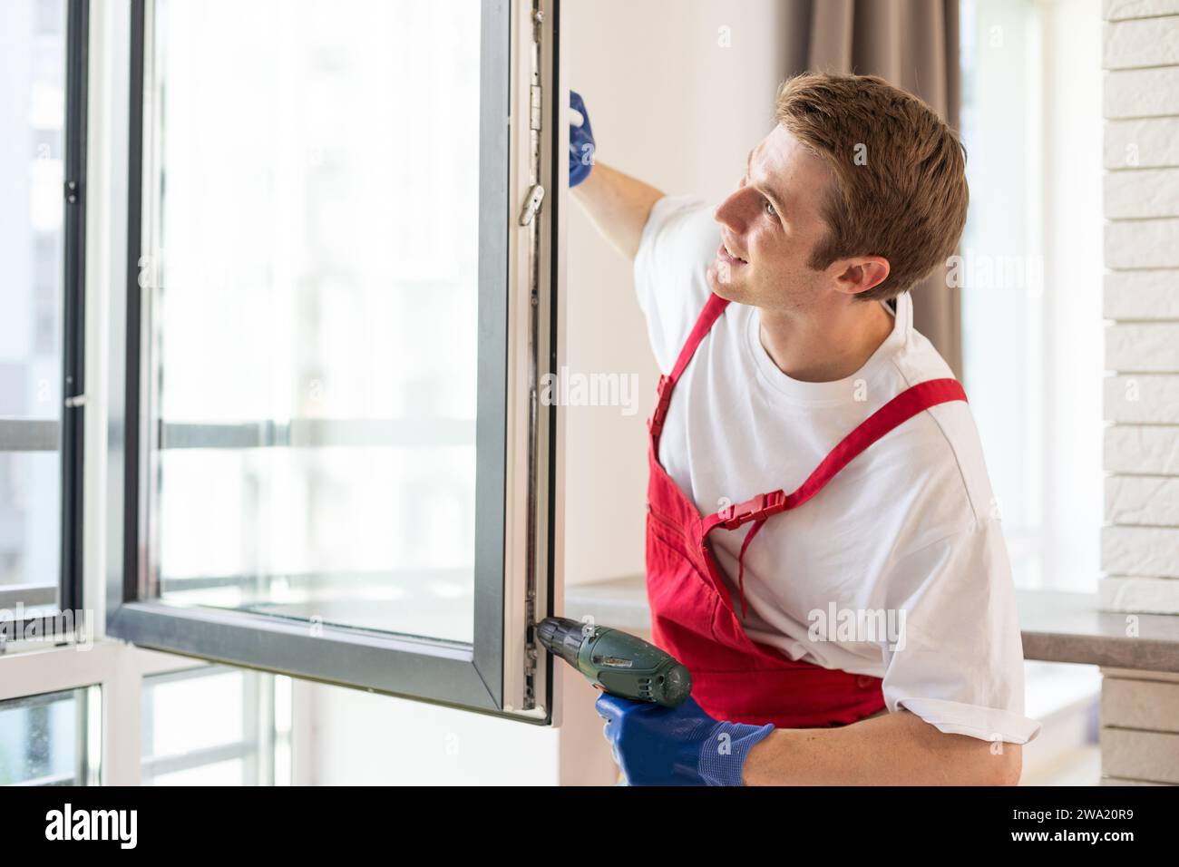 Construction worker installing window in house Stock Photo - Alamy
