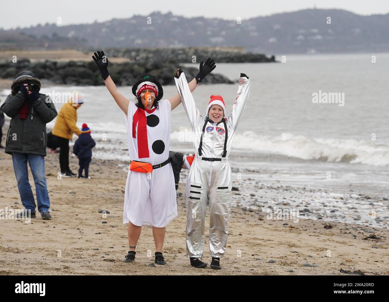 Swimmers arrive to take part in the annual New Year's day charity swim ...