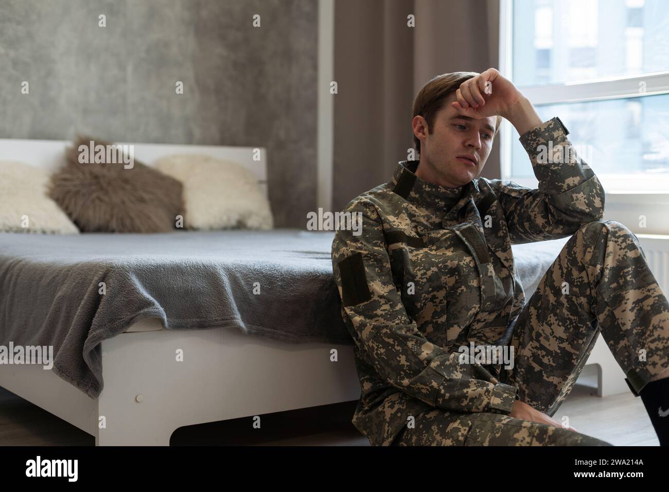 Stressed veteran soldier engrossed in depressive thoughts and memories ...