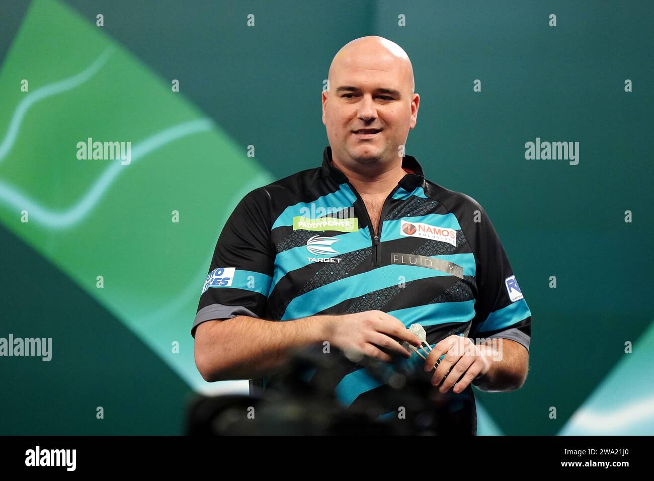 Rob Cross in action against Chris Dobey (not pictured) on day fourteen ...