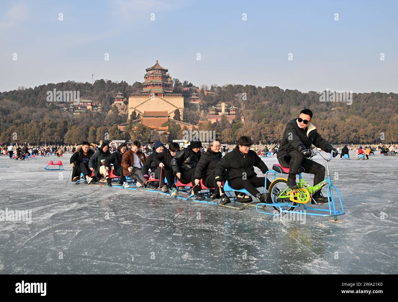 Beijing, China. 1st Jan, 2024. Tourists ride a bicycle combined with ...