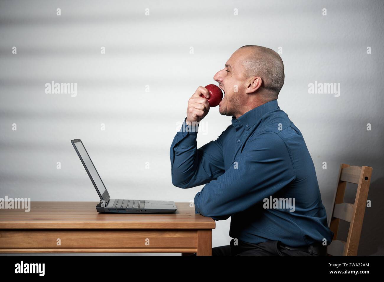 Male teacher eating apple hi-res stock photography and images - Alamy