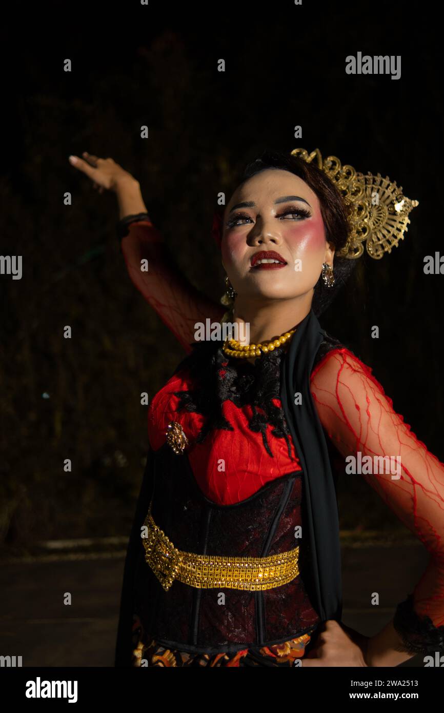 an Asian woman with makeup on her face and wearing a black shawl while ...