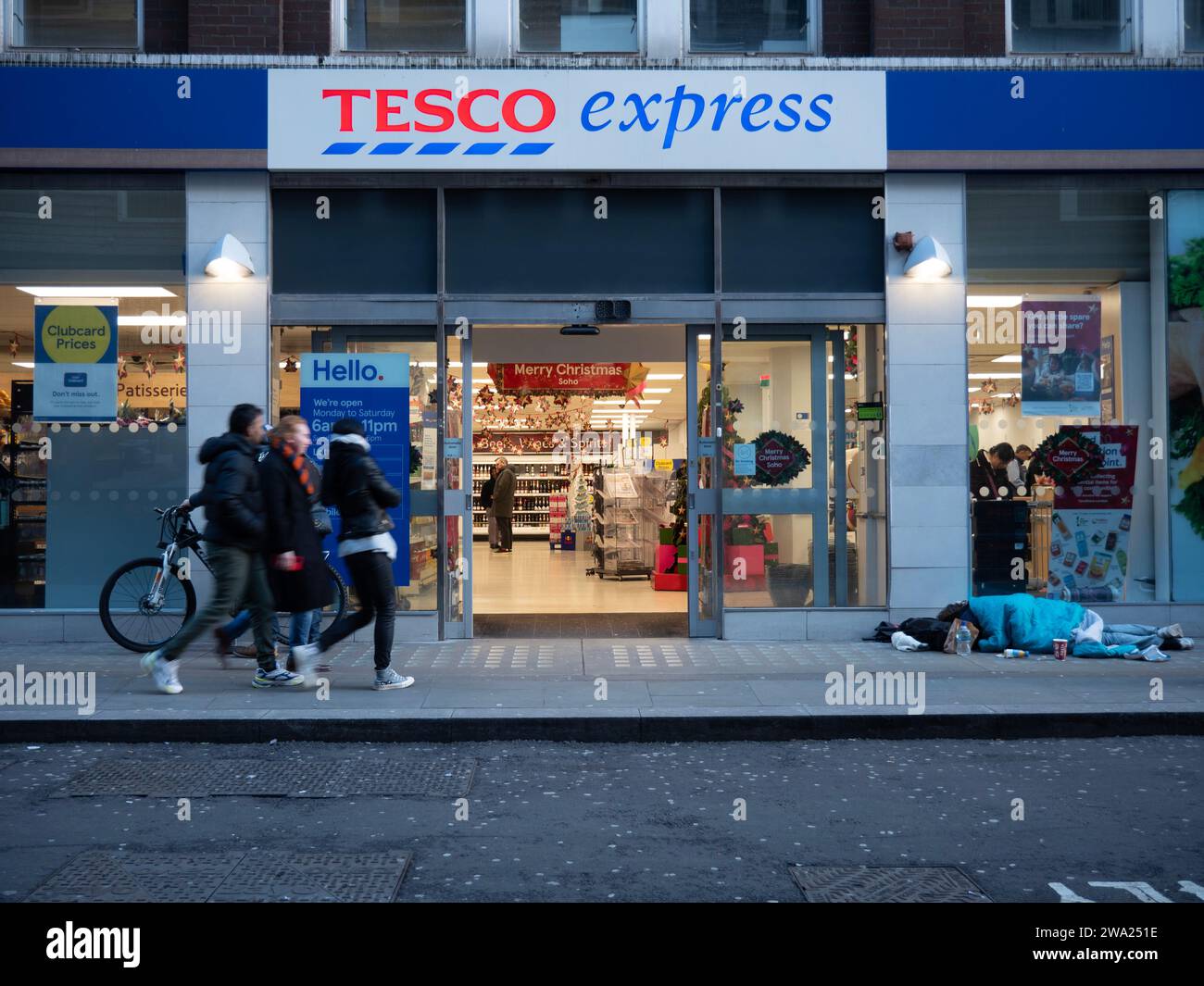 London, UK. Tesco express shop in Central London, with homeless man ...