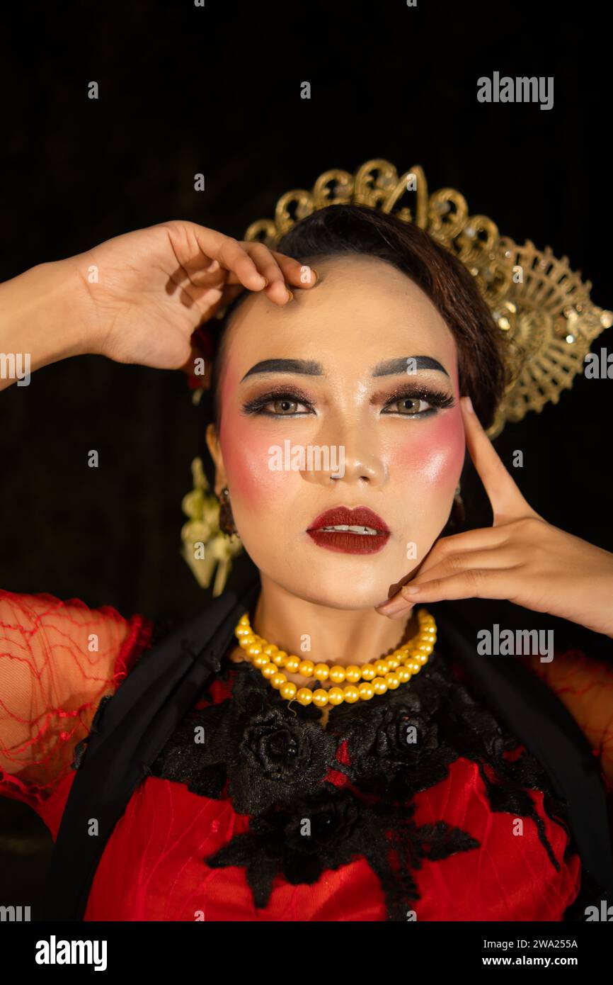 a Sundanese dancer wearing gold jewelry which gives a luxurious feel to ...