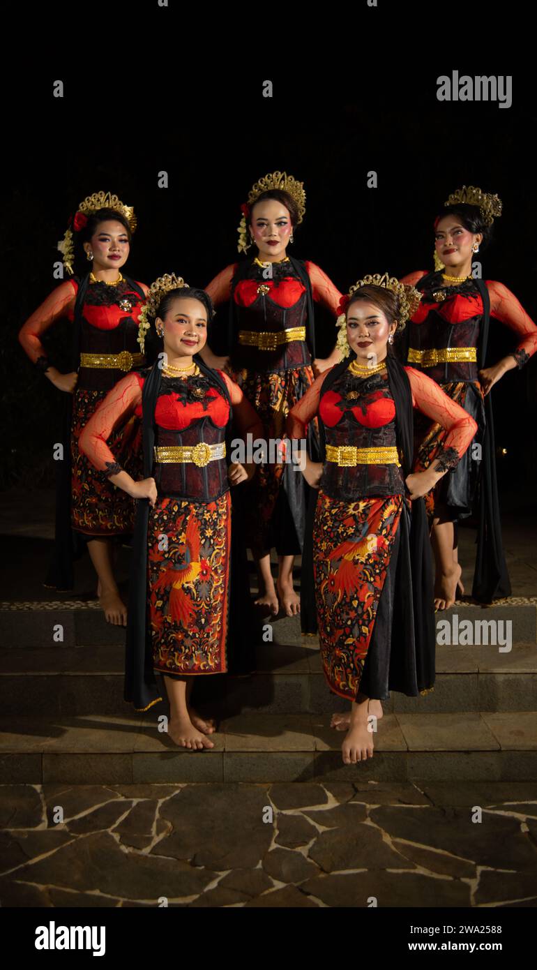 a group of dancers stand and unite in red costumes that show unity at ...