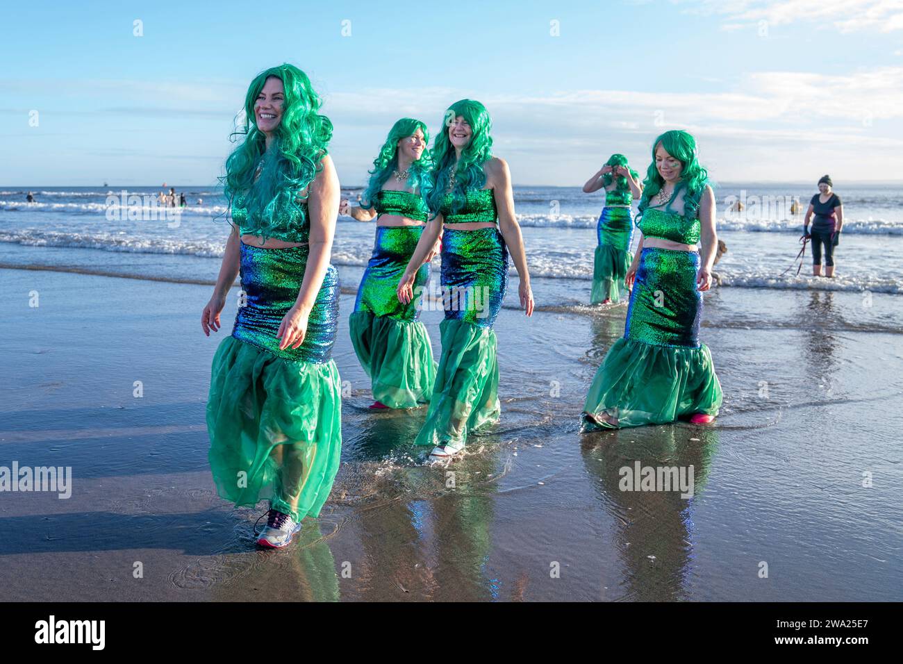 People take part in a Loony Dook New Year's Day dip in the Firth of ...