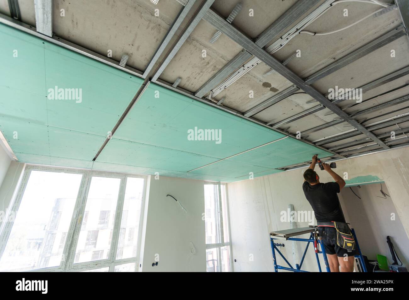 Man assembles profile metal frame for plasterboard ceilings Stock Photo ...