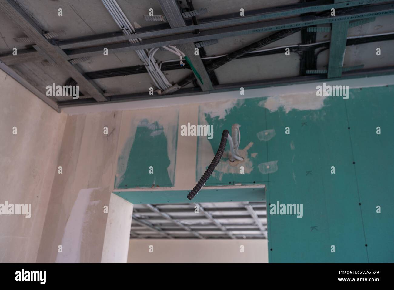 Drywall installation work in progress by construction workers at ...