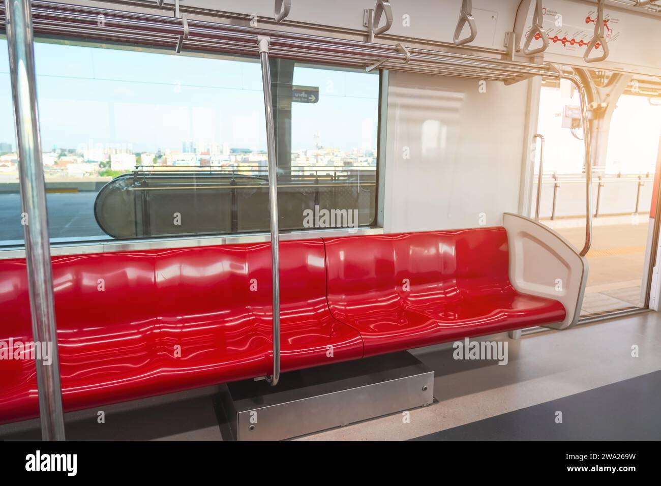Interior of a passenger car of a commuter train. Red plastic seats and ...