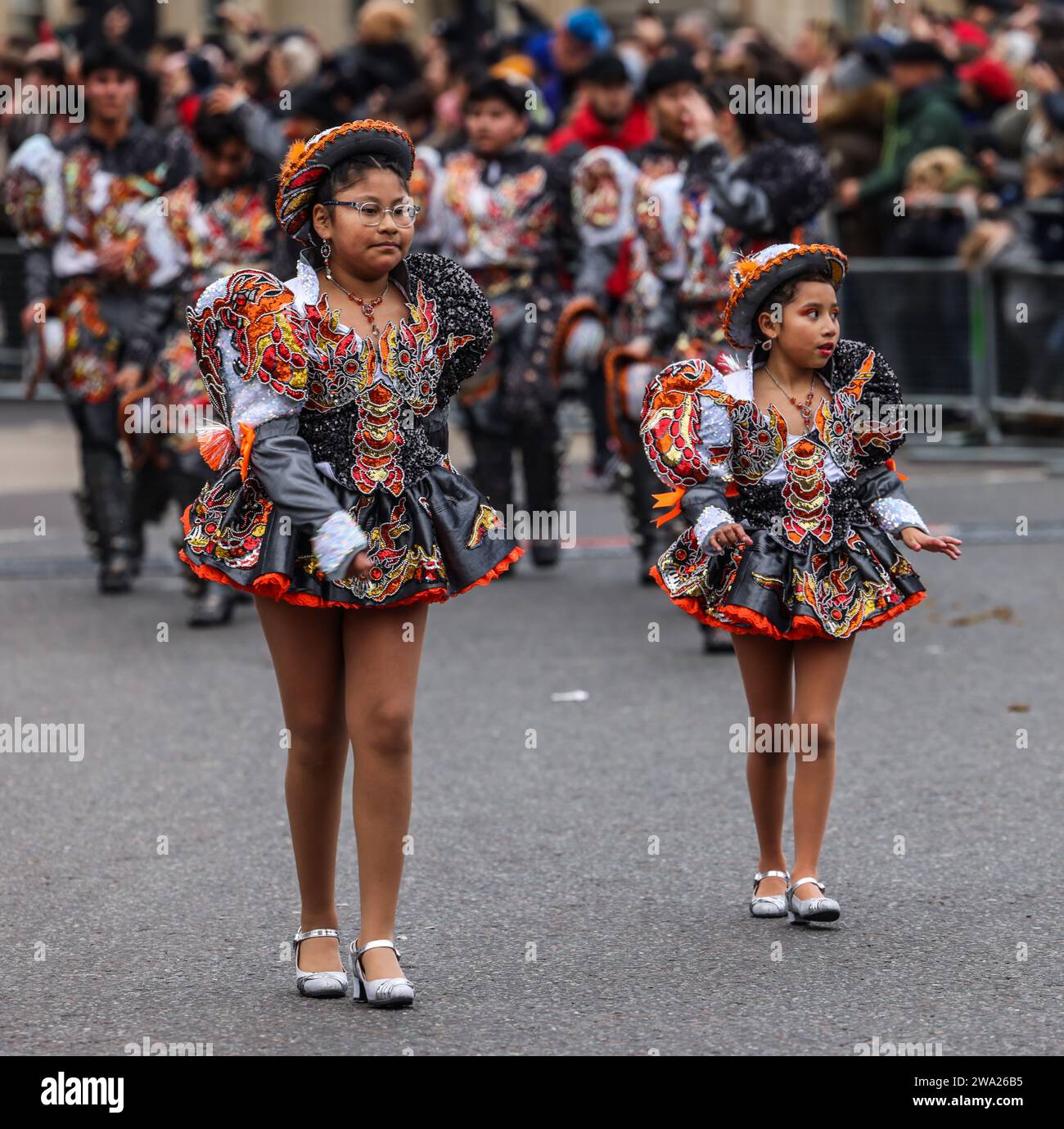London, UK. 01st Jan, 2024. Crowds line up the streets of Central London today to enjoy The 37th ...