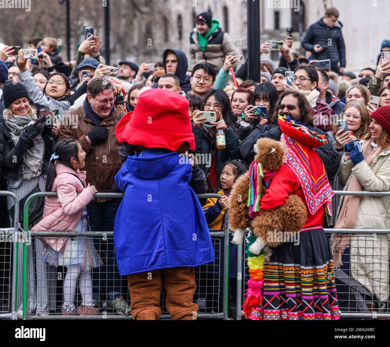 London, UK. 01st Jan, 2024. Crowds line up the streets of Central London today to enjoy The 37th ...