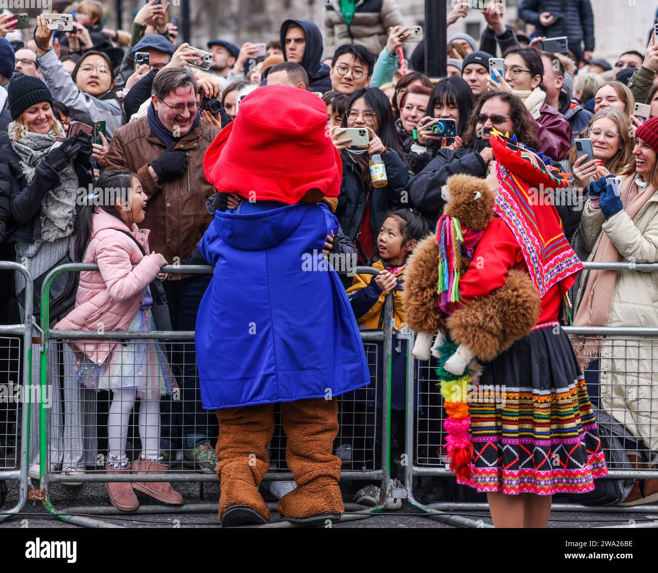 London, UK. 01st Jan, 2024. Crowds line up the streets of Central London today to enjoy The 37th ...