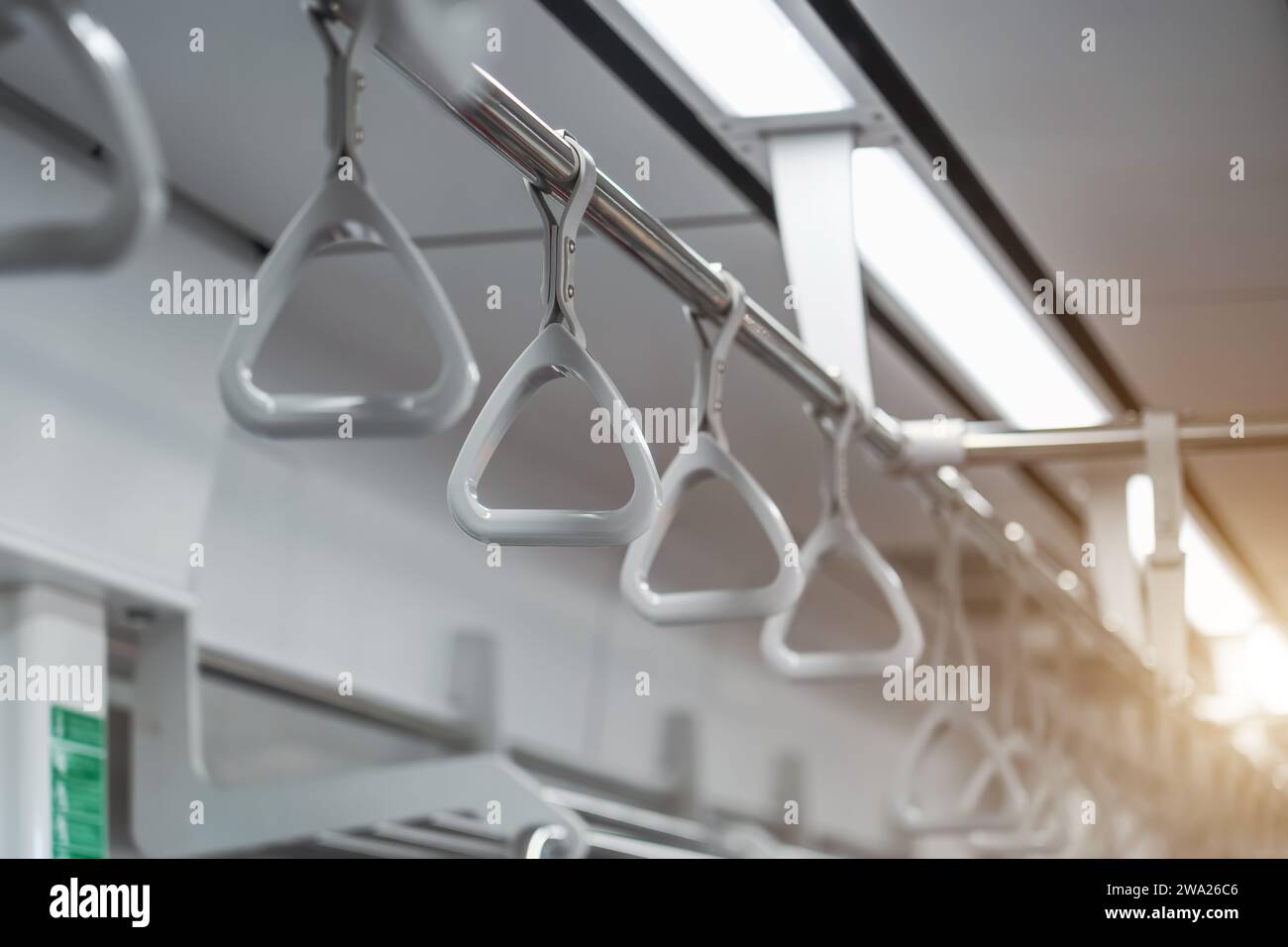 Individual handles on metal handrails inside the train Stock Photo - Alamy