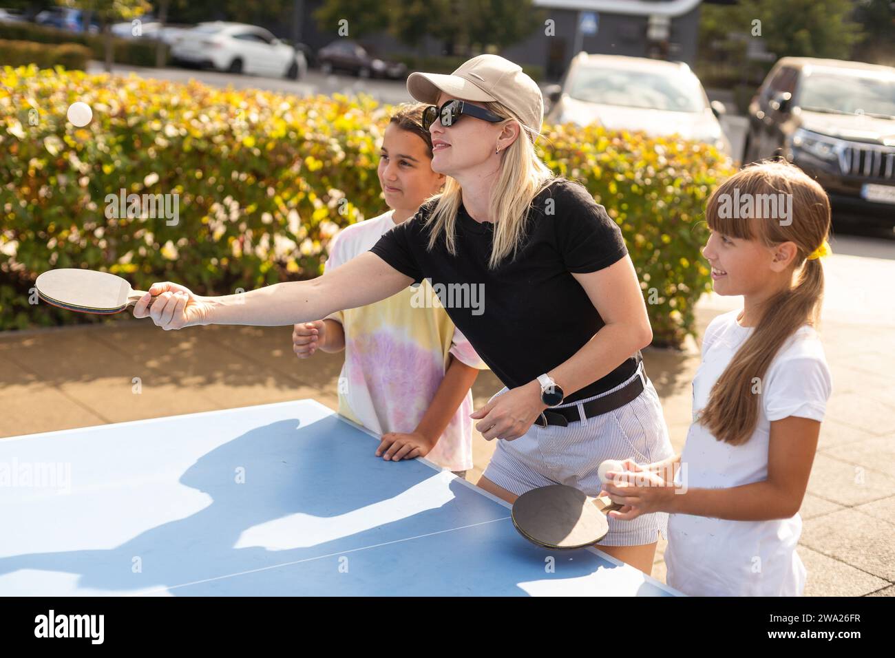 Family playing table tennis in the summer outdoors Stock Photo - Alamy