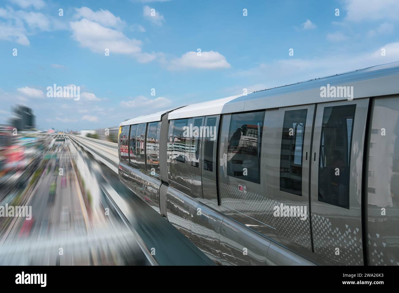 Modern high speed electric train departs from a station with motion ...