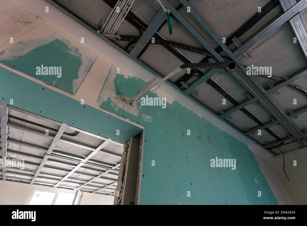Drywall installation work in progress by construction workers at ...