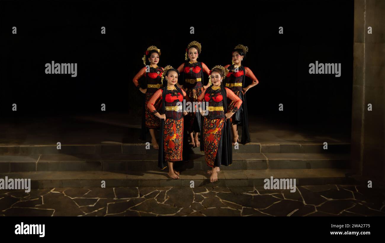 a group of dancers stand and unite in red costumes that show unity at ...