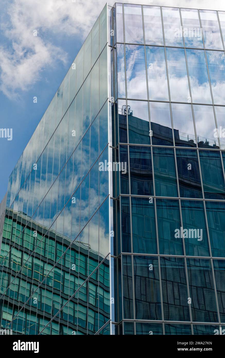860 Washington Street, a parallelogram-shaped blue glass box, reflects ...