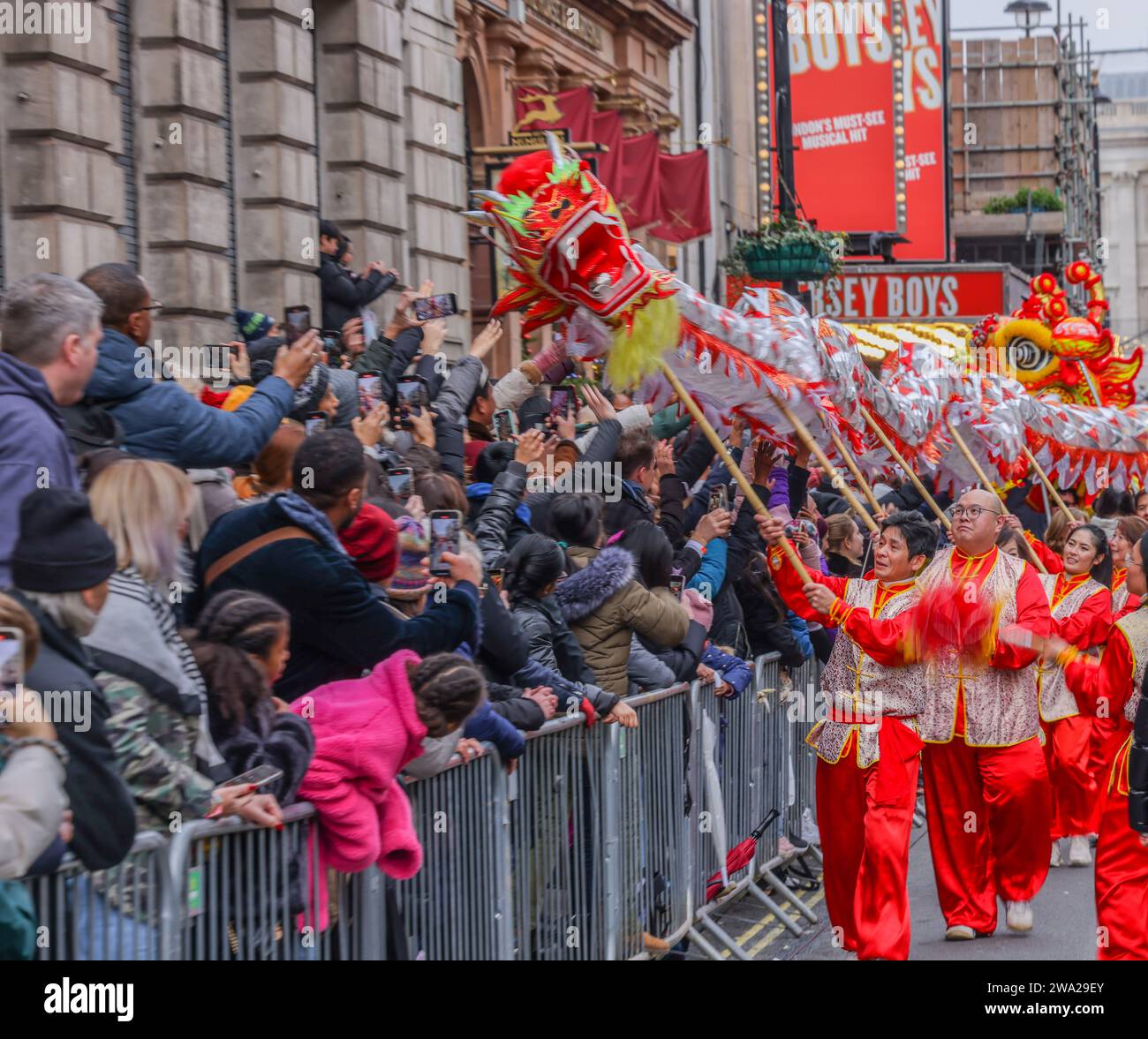 London, UK. 01st Jan, 2024. Crowds line up the streets of Central London today to enjoy The 37th ...