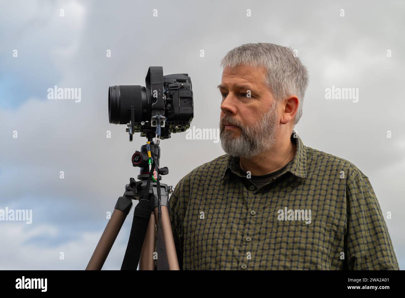Photographer at work, gray hair and full beard, 56 years old, looks ...