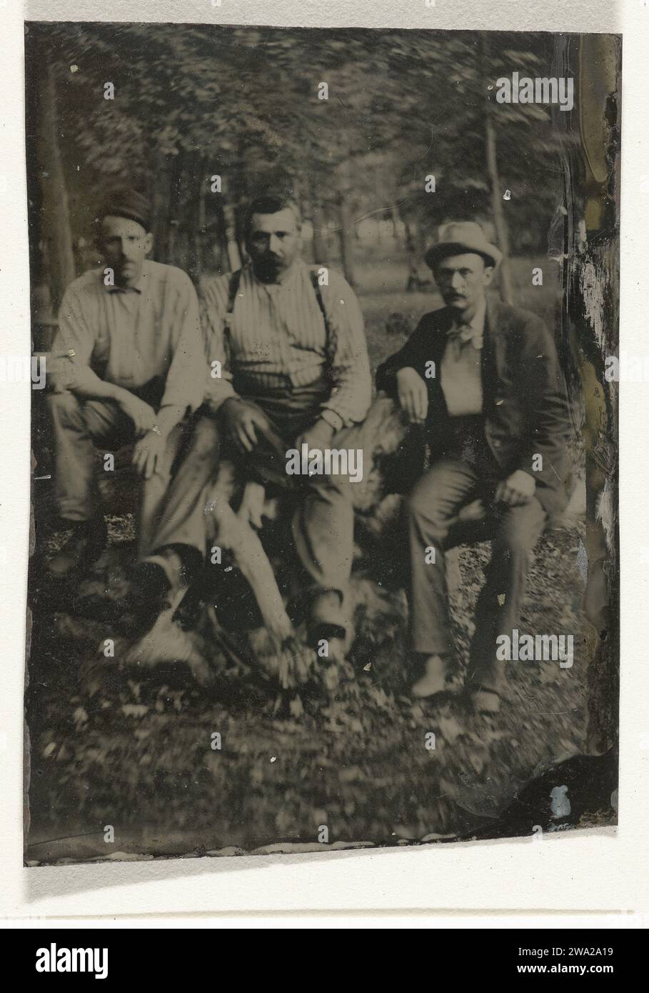 Portrait of three men, sitting (on a tree stump?) In a forest, c. 1880 ...