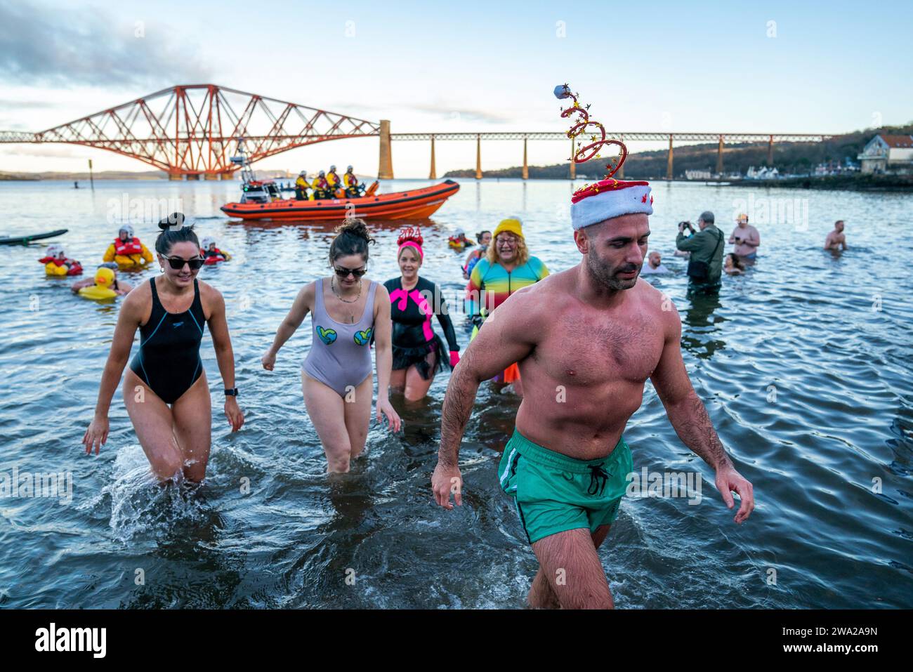 People take part in the Loony Dook New Year's Day dip in the Firth of ...