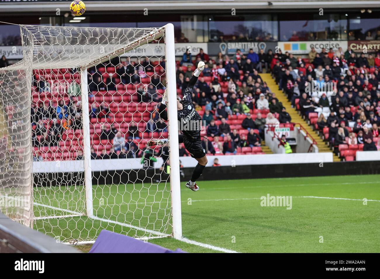 Sam Tickle of Wigan Athletic saves a shot off Devante Cole of Barnsley ...