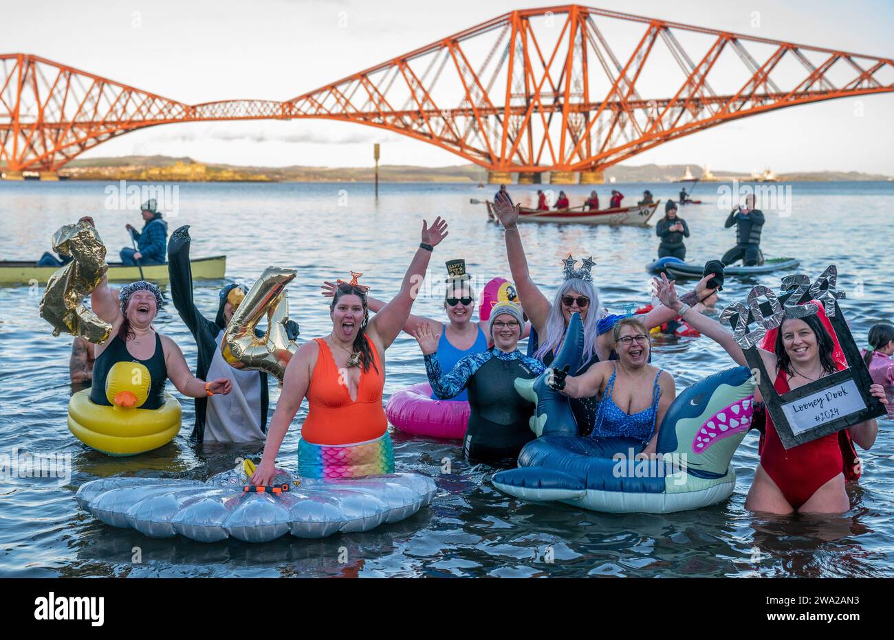 People take part in the Loony Dook New Year's Day dip in the Firth of ...