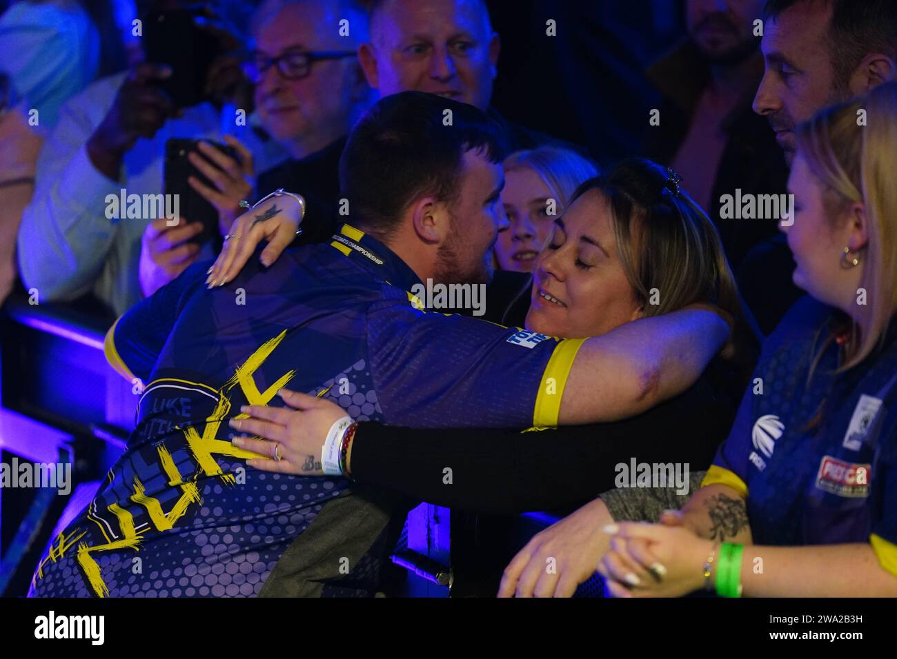 Luke Littler greets family before his match against Brendan Dolan (not ...