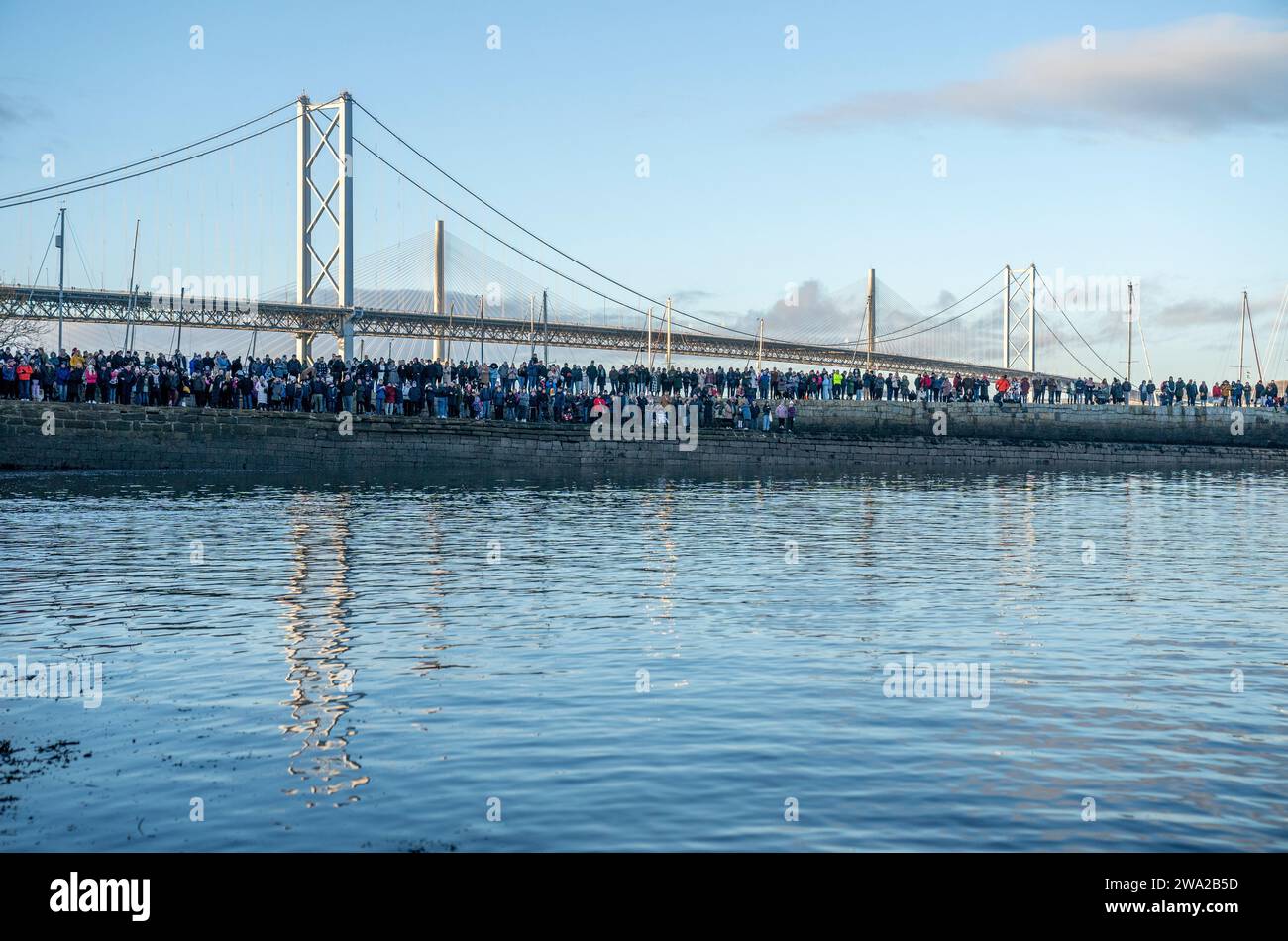 Crowds gather along the harbour to watch people take part in the Loony ...