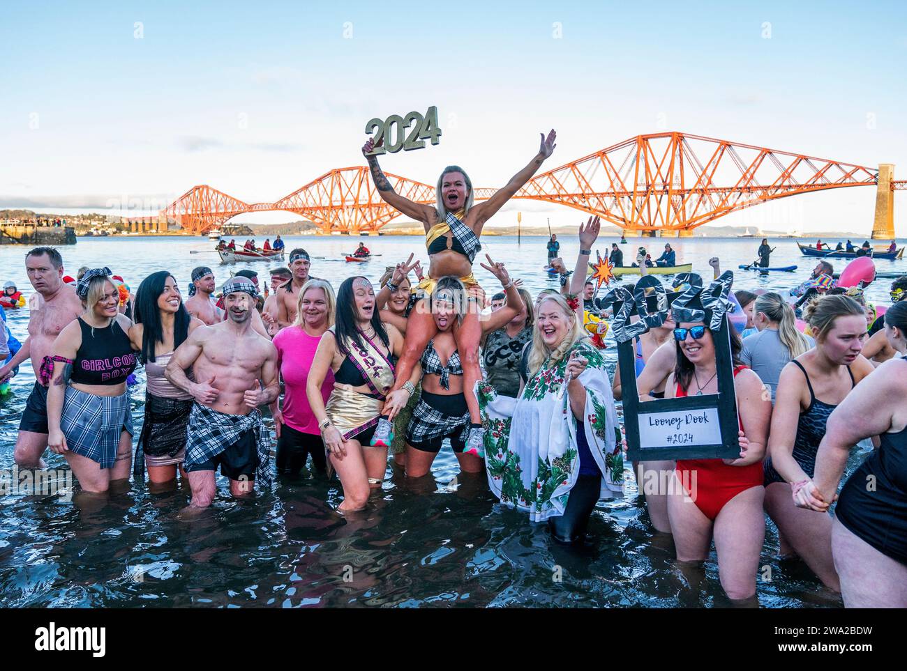 People take part in the Loony Dook New Year's Day dip in the Firth of ...