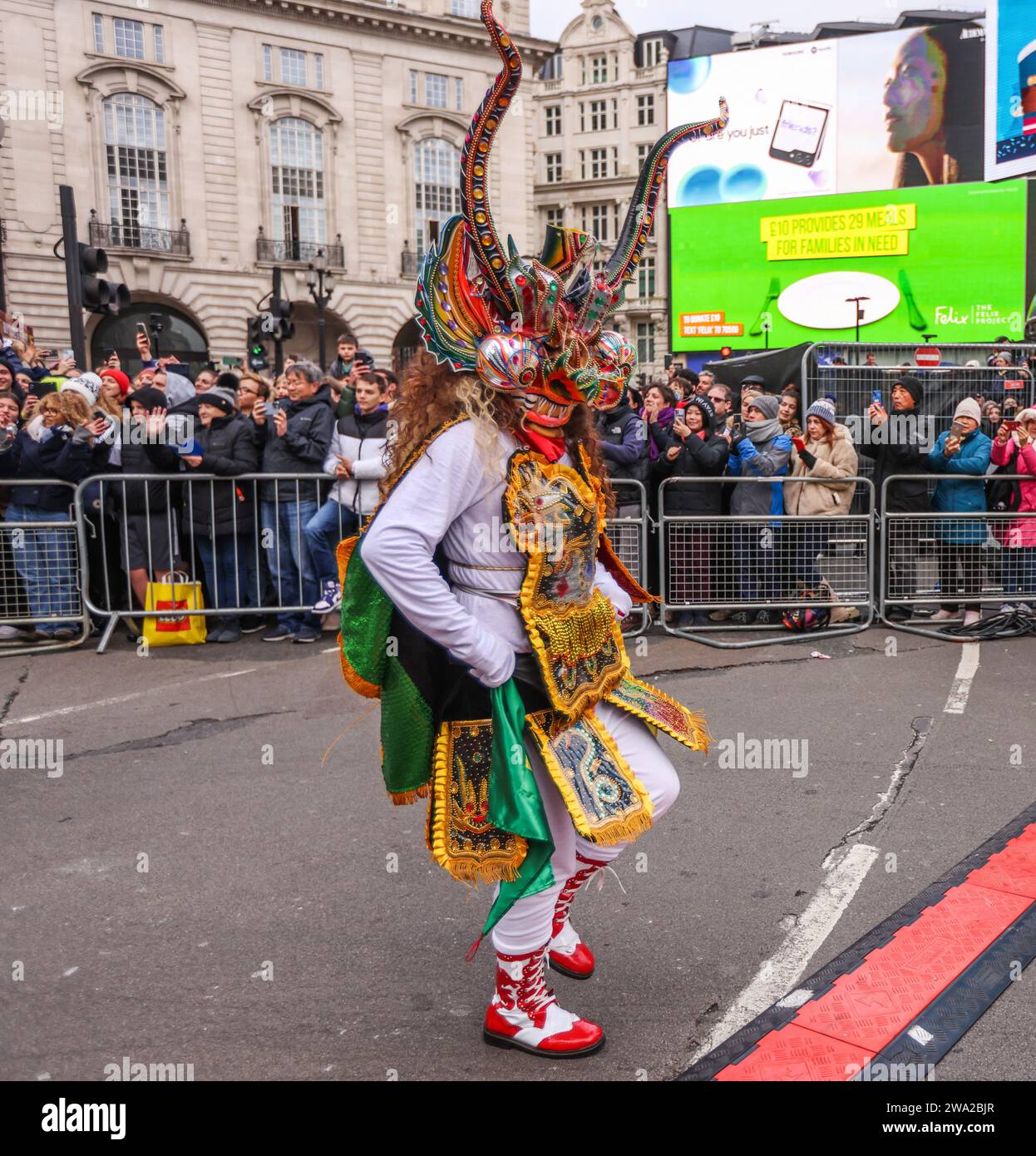London, UK. 01st Jan, 2024. Crowds line up the streets of Central London today to enjoy The 37th ...