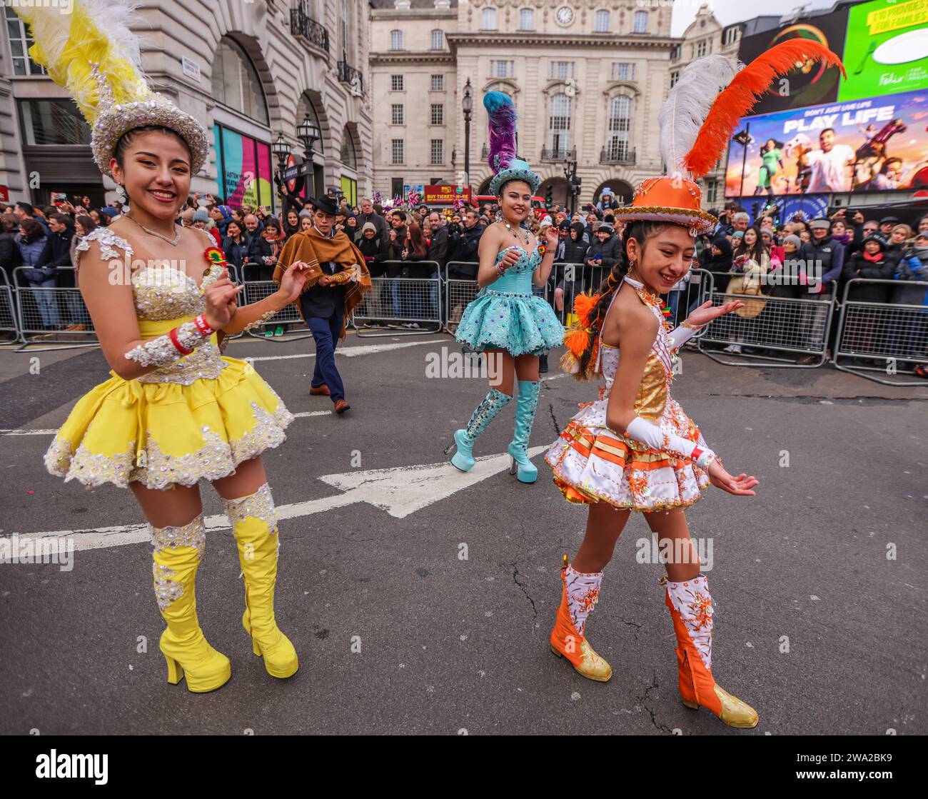 London, UK. 01st Jan, 2024. Crowds line up the streets of Central London today to enjoy The 37th ...