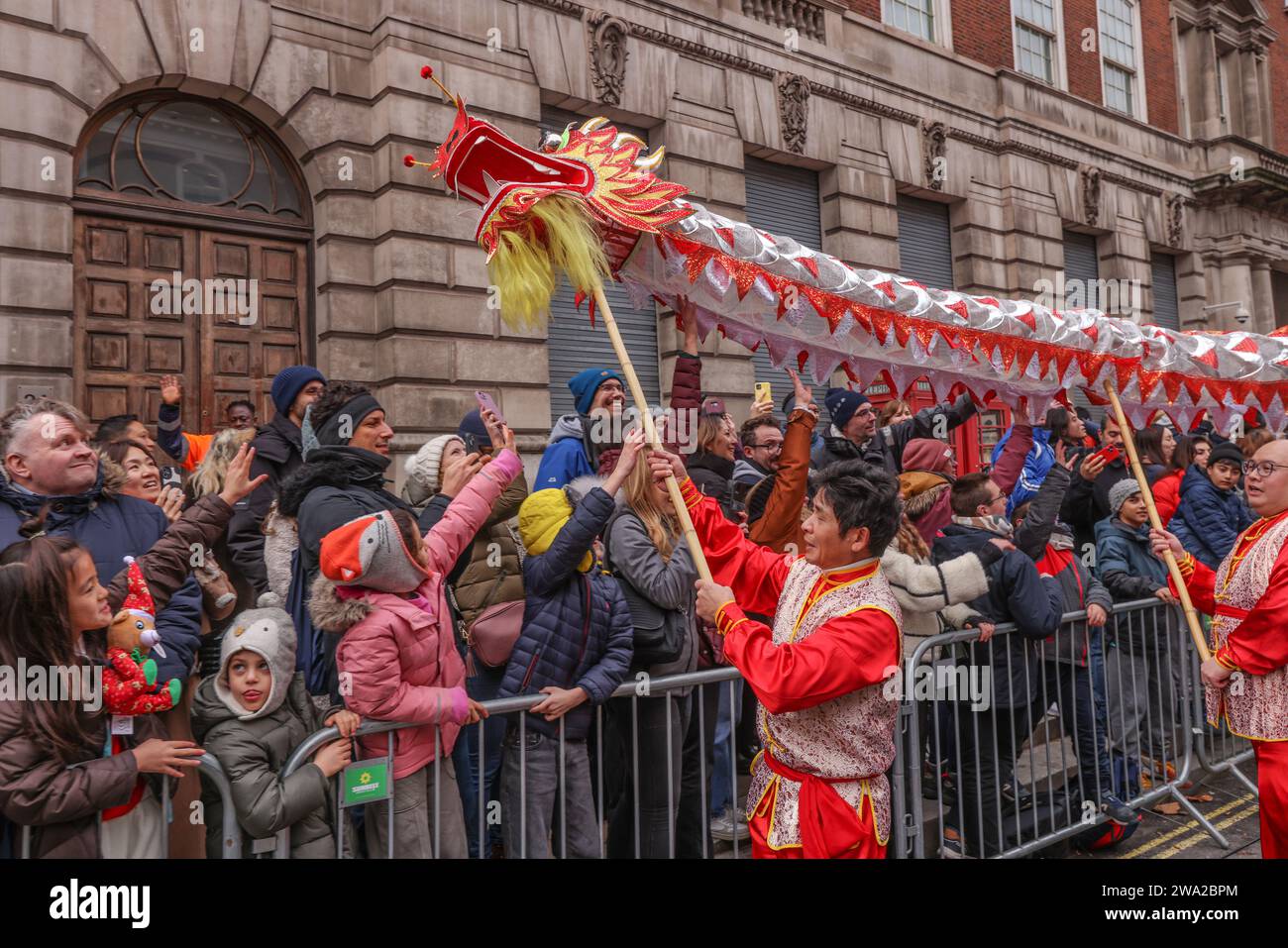 London, UK. 01st Jan, 2024. Crowds line up the streets of Central London today to enjoy The 37th ...