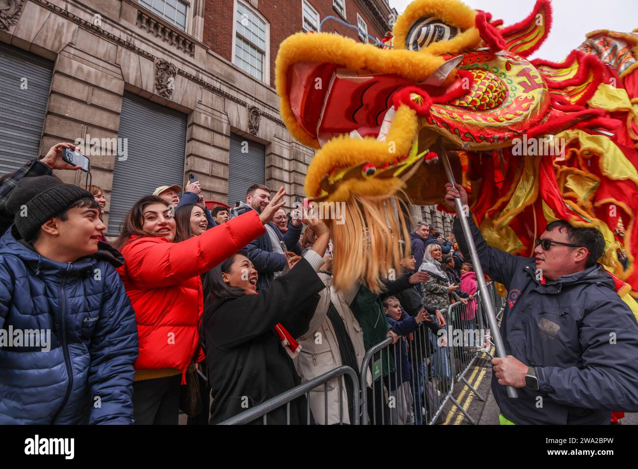 London, UK. 01st Jan, 2024. Crowds line up the streets of Central London today to enjoy The 37th ...