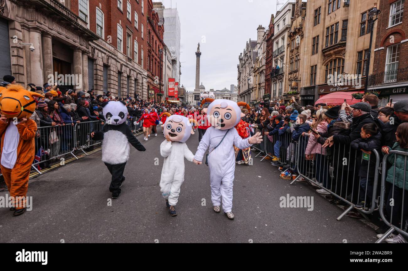 London, UK. 01st Jan, 2024. Crowds line up the streets of Central London today to enjoy The 37th ...