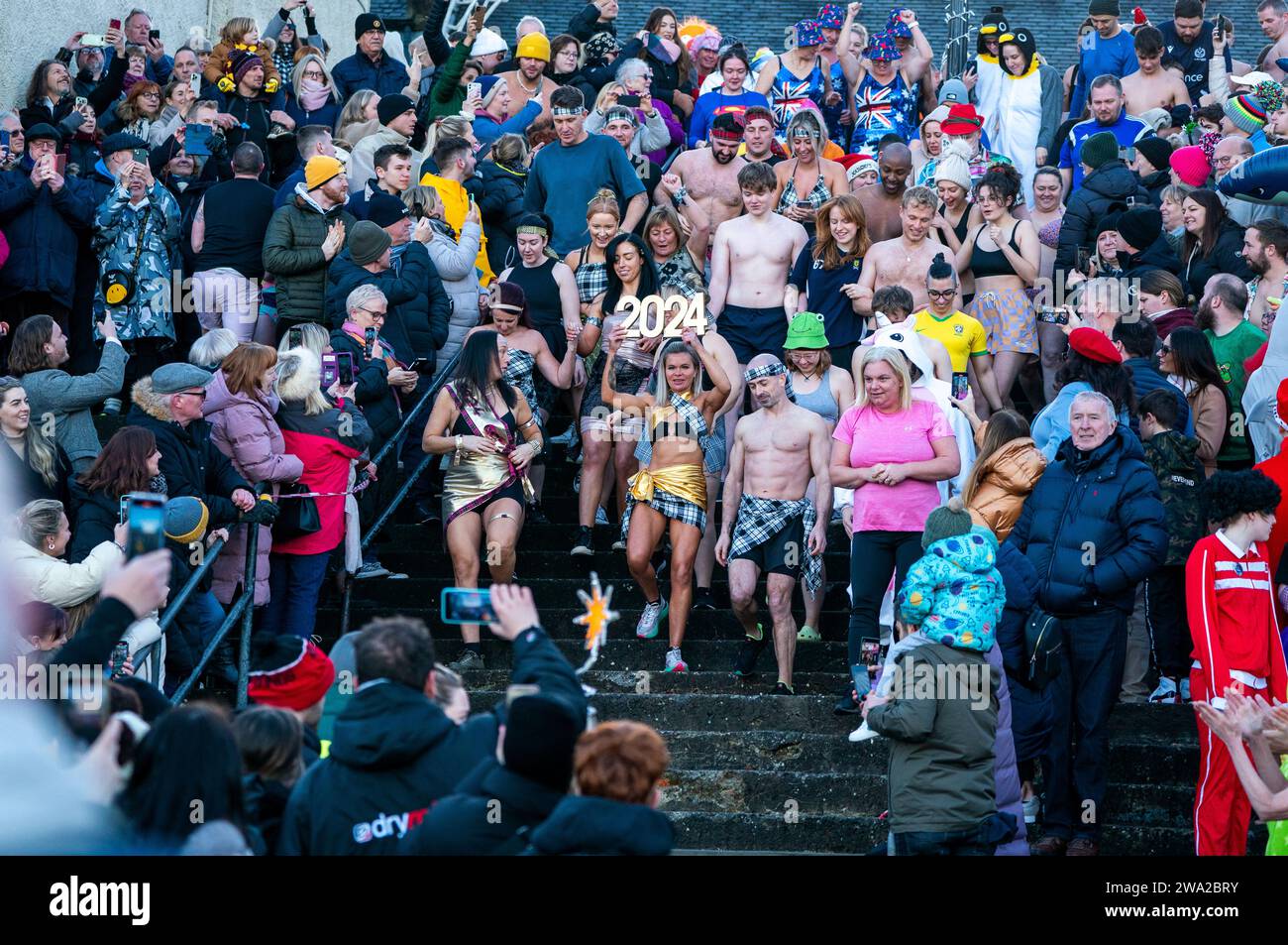 People head to the beach to take part in the Loony Dook New Year's Day ...