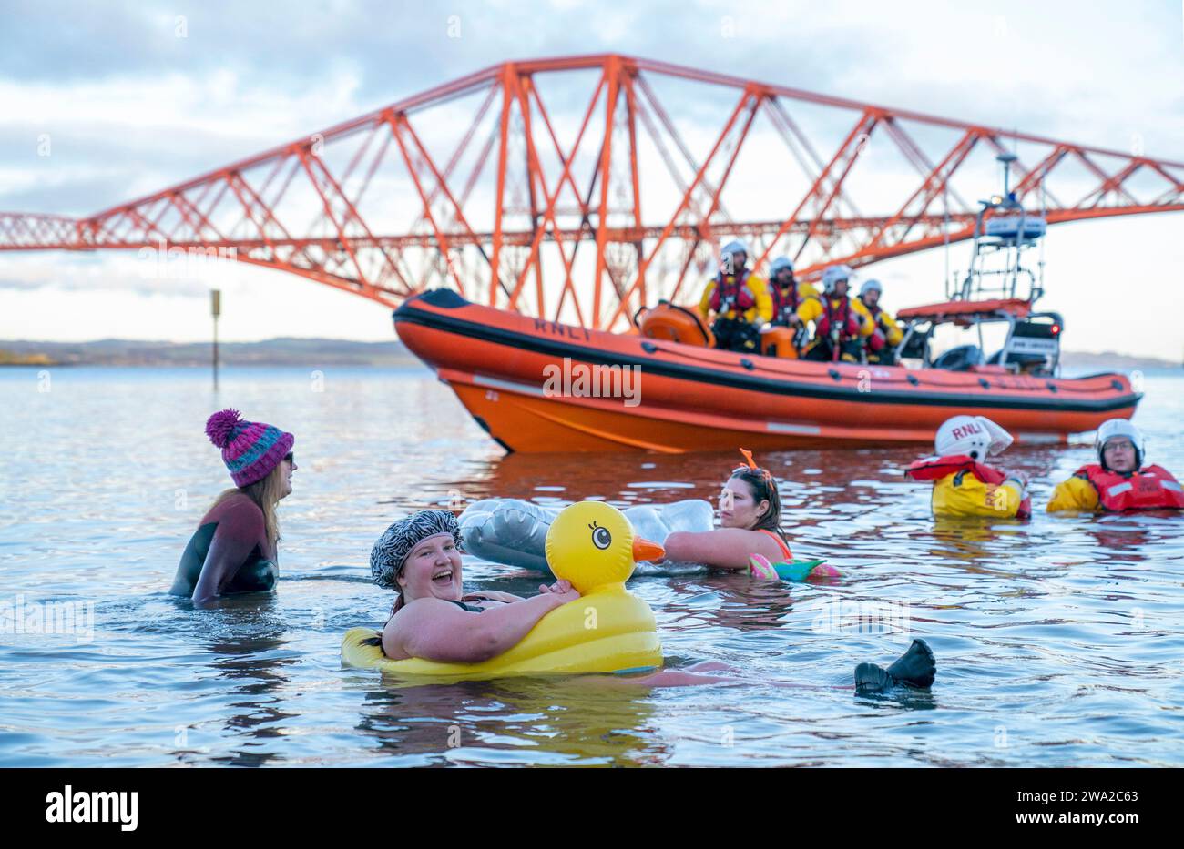 People take part in the Loony Dook New Year's Day dip in the Firth of ...