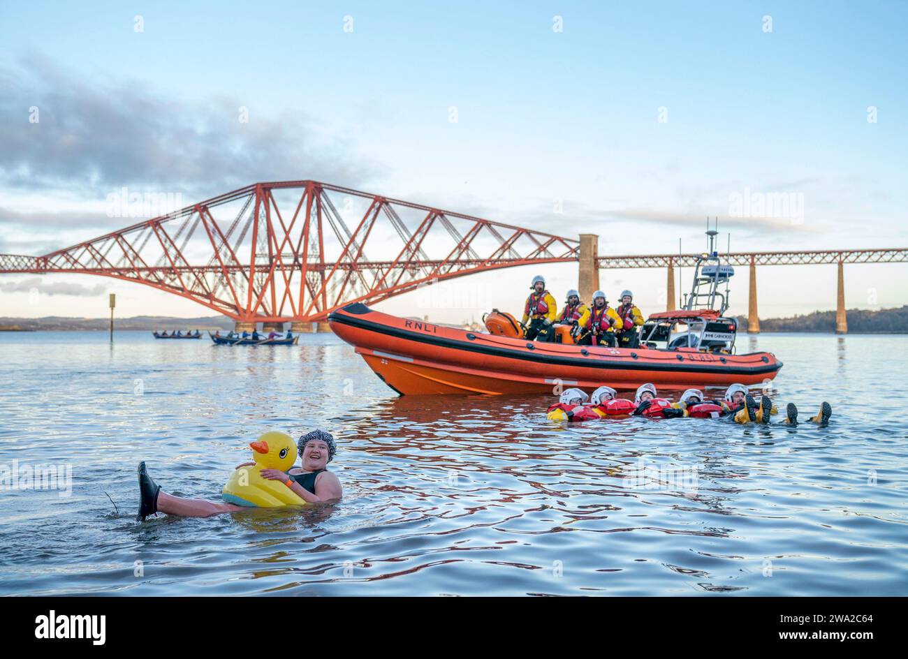 People take part in the Loony Dook New Year's Day dip in the Firth of ...