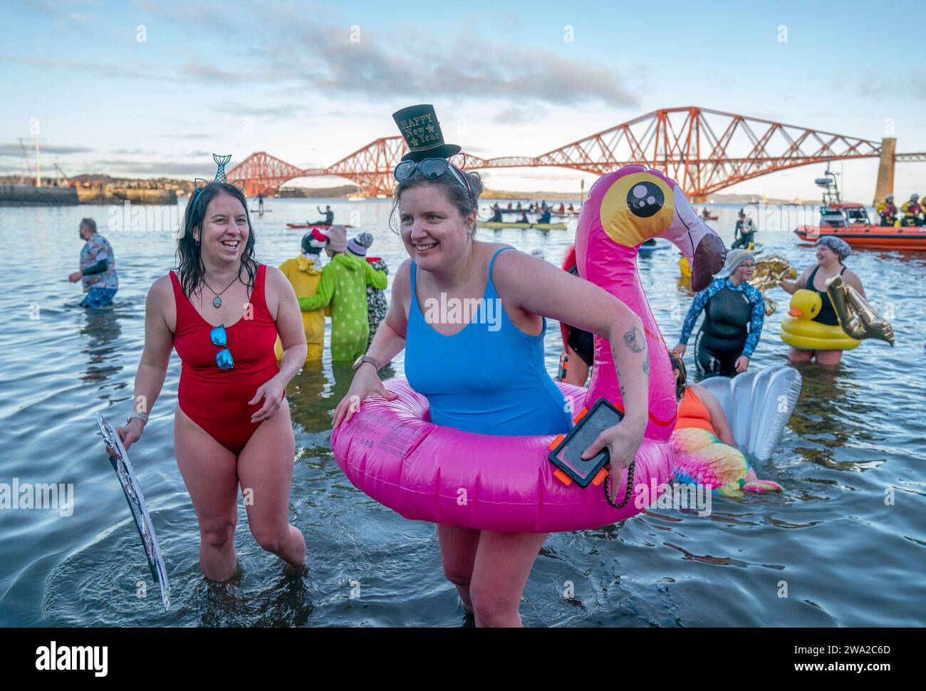 People take part in the Loony Dook New Year's Day dip in the Firth of ...