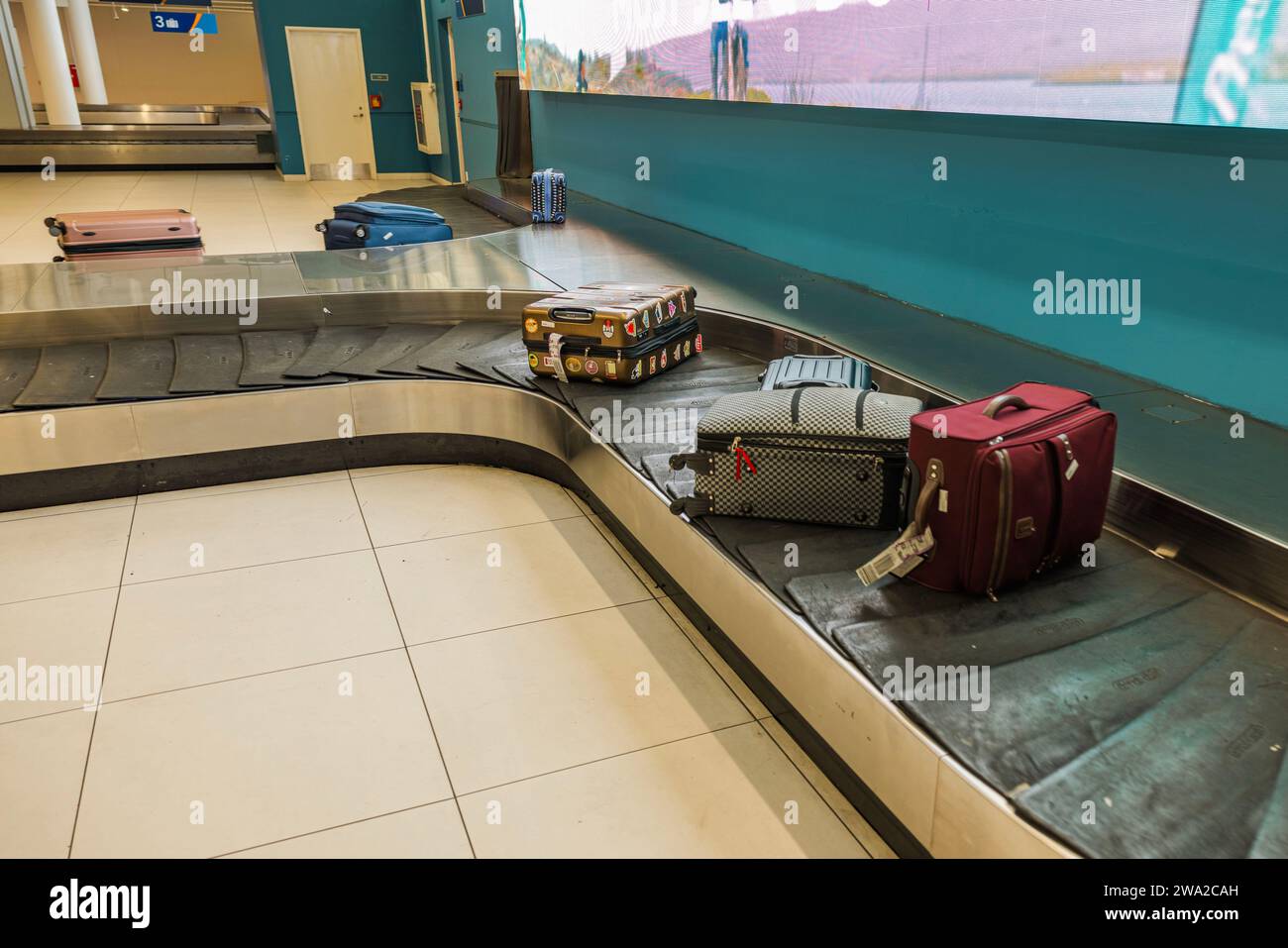View of baggage carousel in Willemstad Airport, at luggage pick-up area ...
